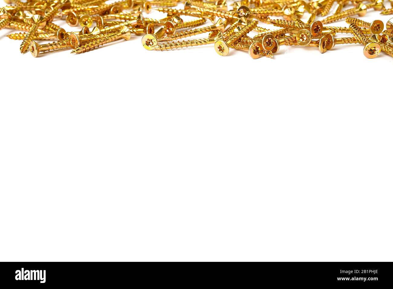 Gold screws scattered randomly on a white background. Torx yellow zinc ...