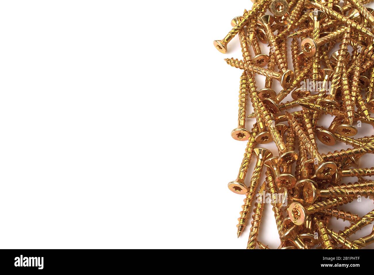 Gold screws scattered randomly on a white background. Torx yellow zinc ...