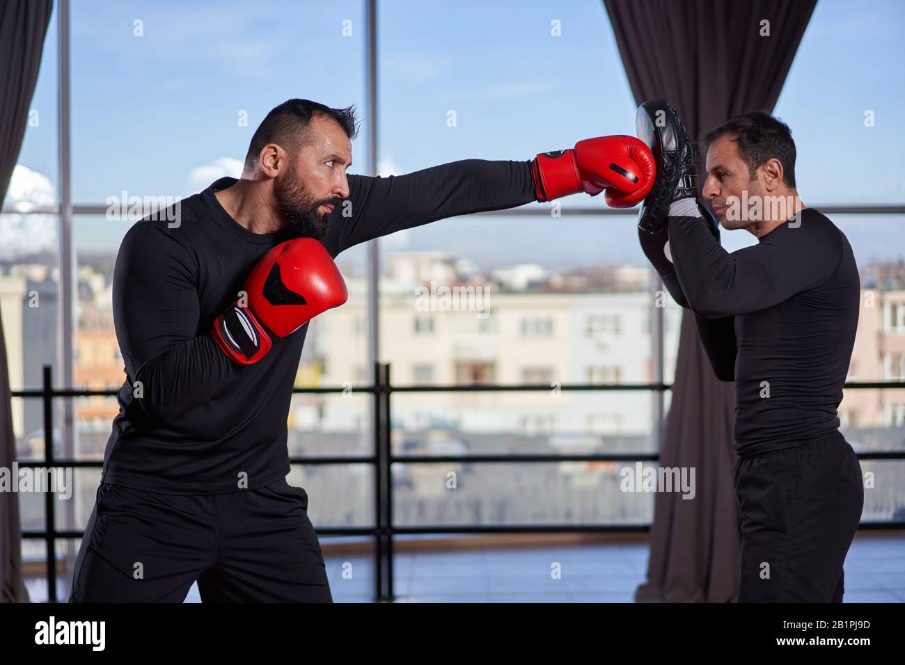 Boxer hitting mitts with his coach in the gym Stock Photo - Alamy