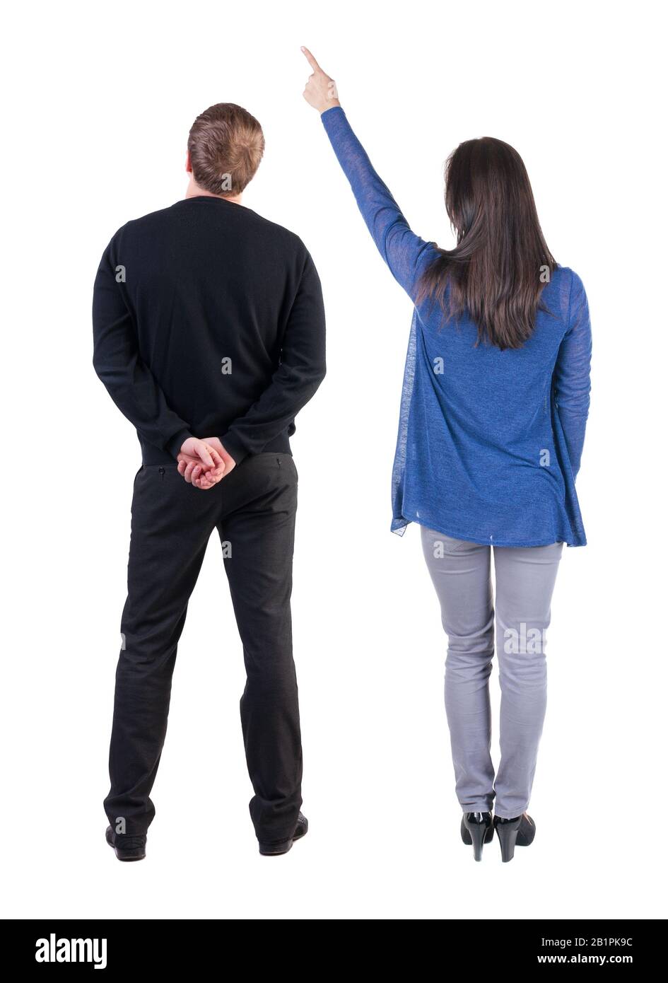 Back view of couple couple in sweater pointing. Rear view people ...
