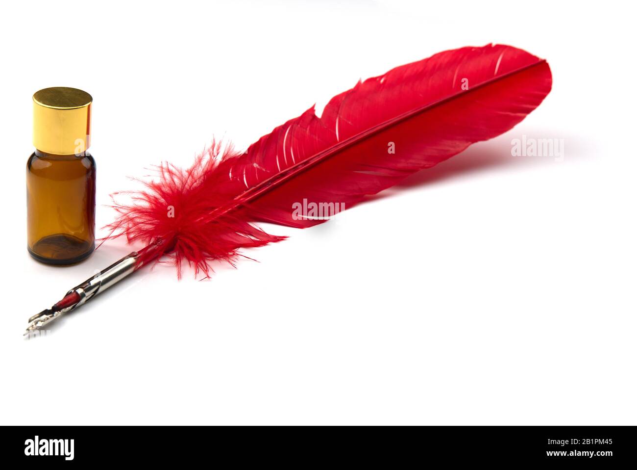 A red feather pen isolated on white background Stock Photo - Alamy