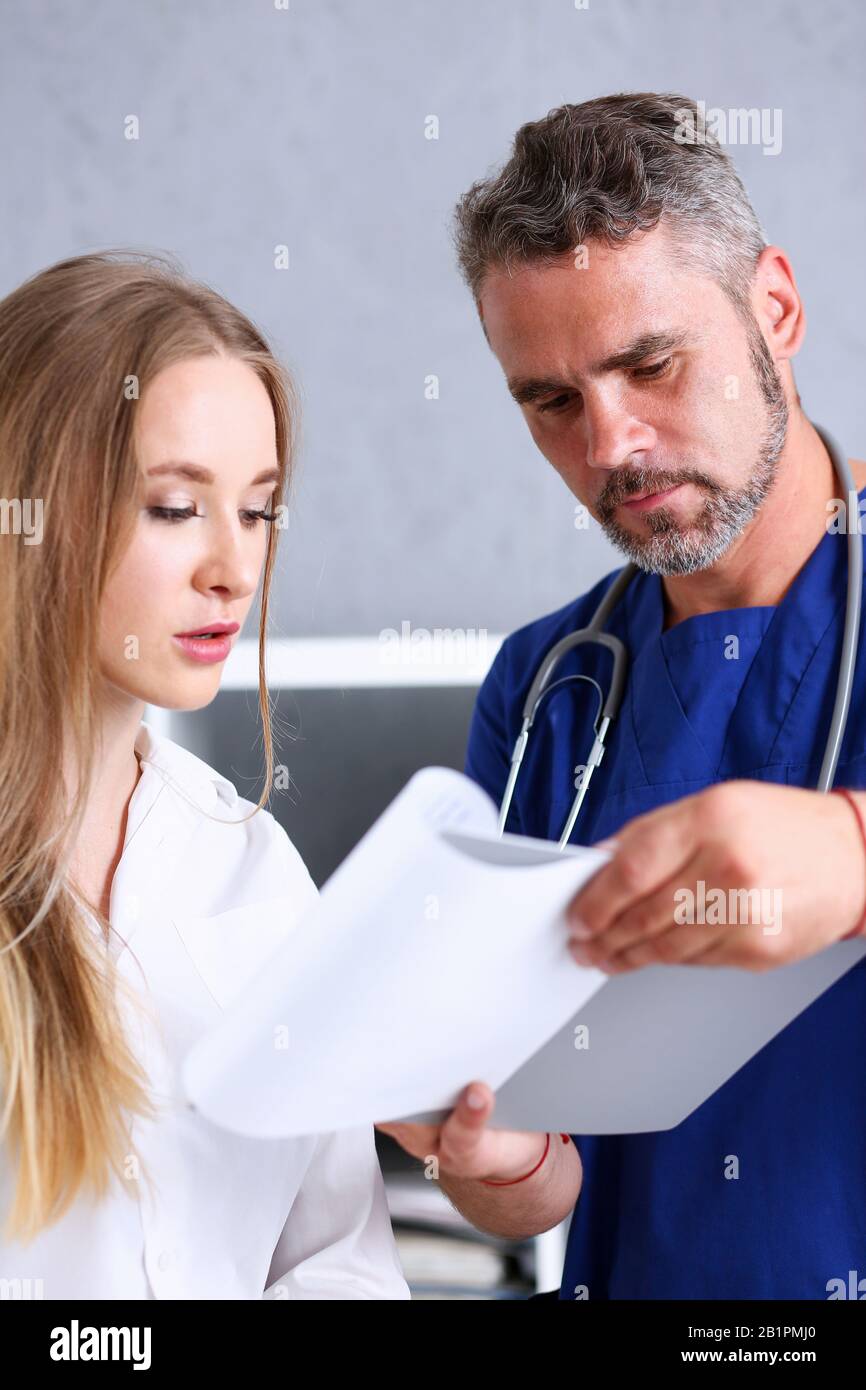 Concerned handsome doctor communicate with patient Stock Photo - Alamy