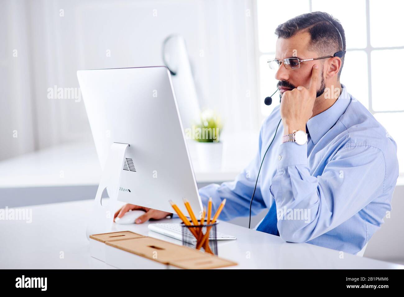 Young handsome male technical support dispatcher in call center Stock ...