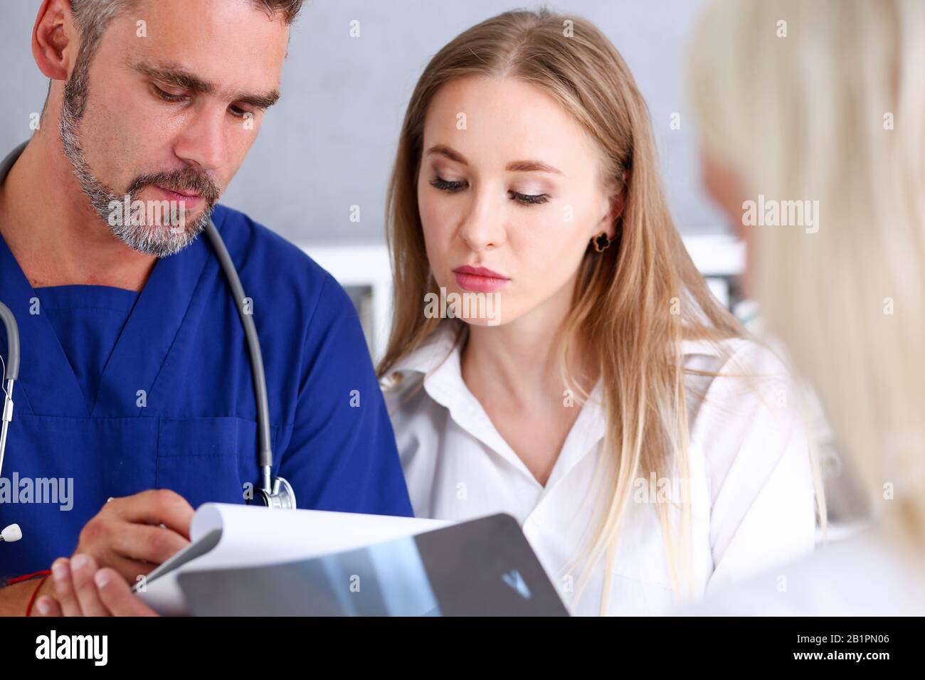 Concerned handsome doctor communicate with patient Stock Photo - Alamy