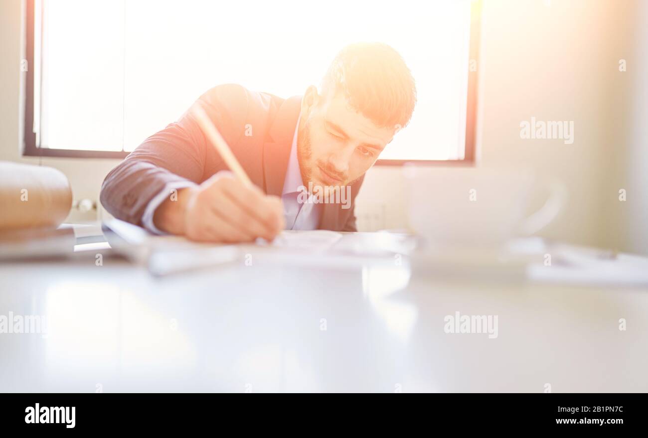 Architect planning a draft in the office Stock Photo - Alamy
