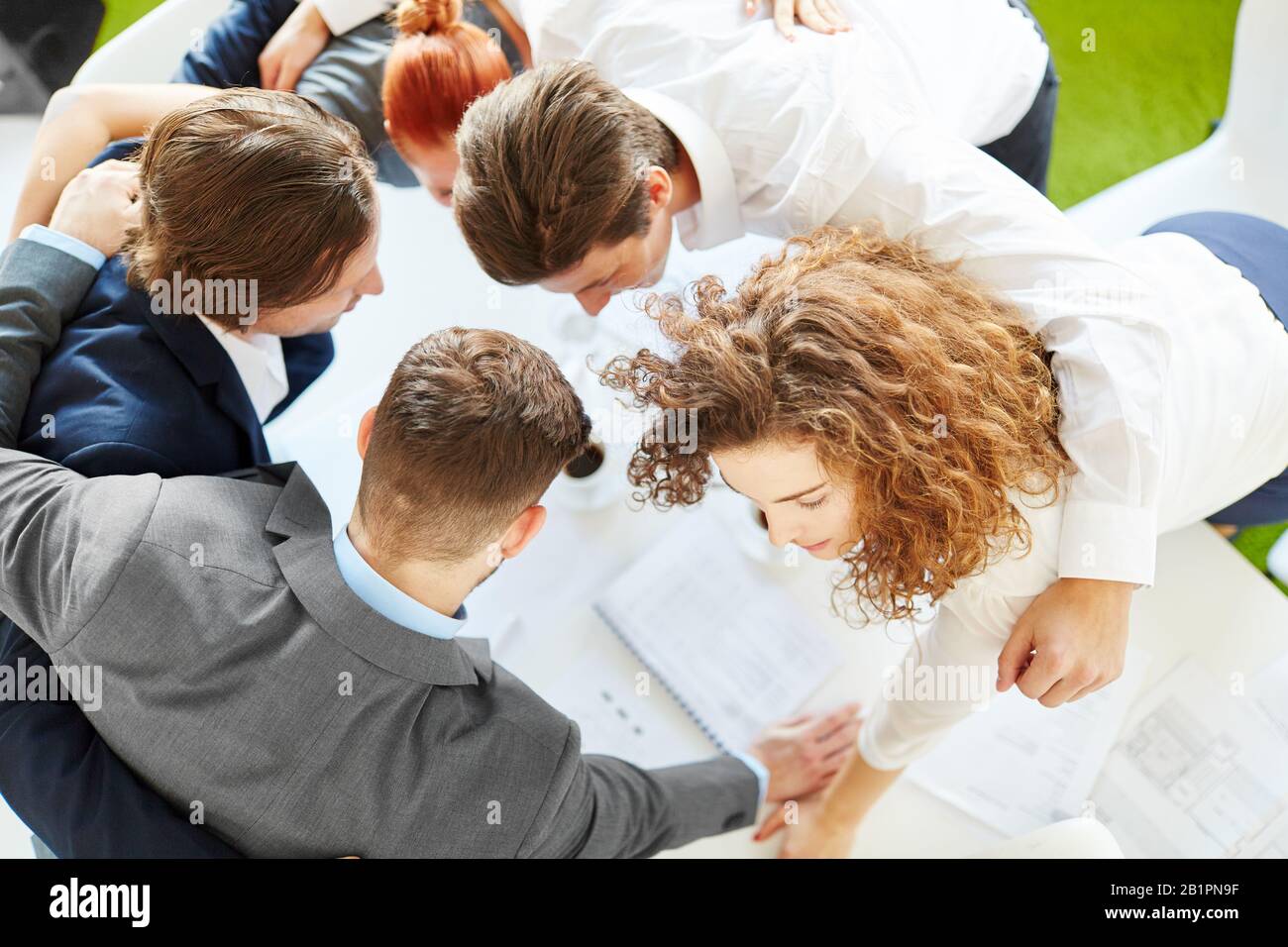 Motivation in the business team through a mutual hug in the office ...