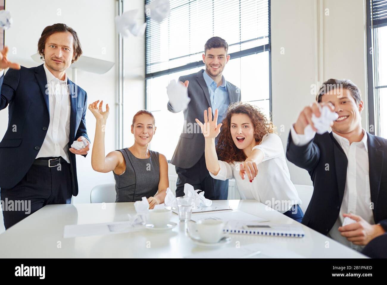 Cheerful start-up team throws paper in the office Stock Photo - Alamy