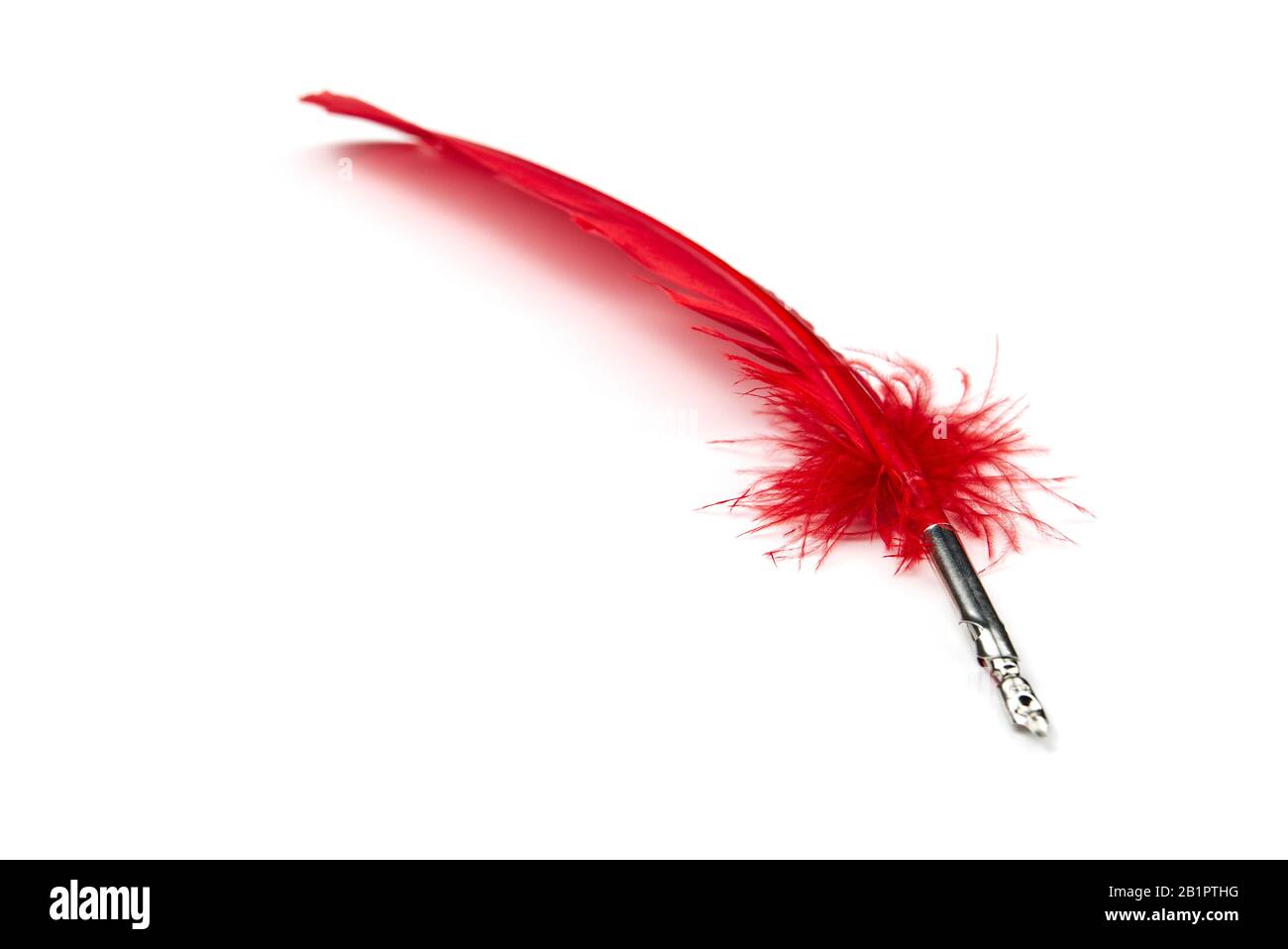 A red feather pen isolated on white background Stock Photo - Alamy