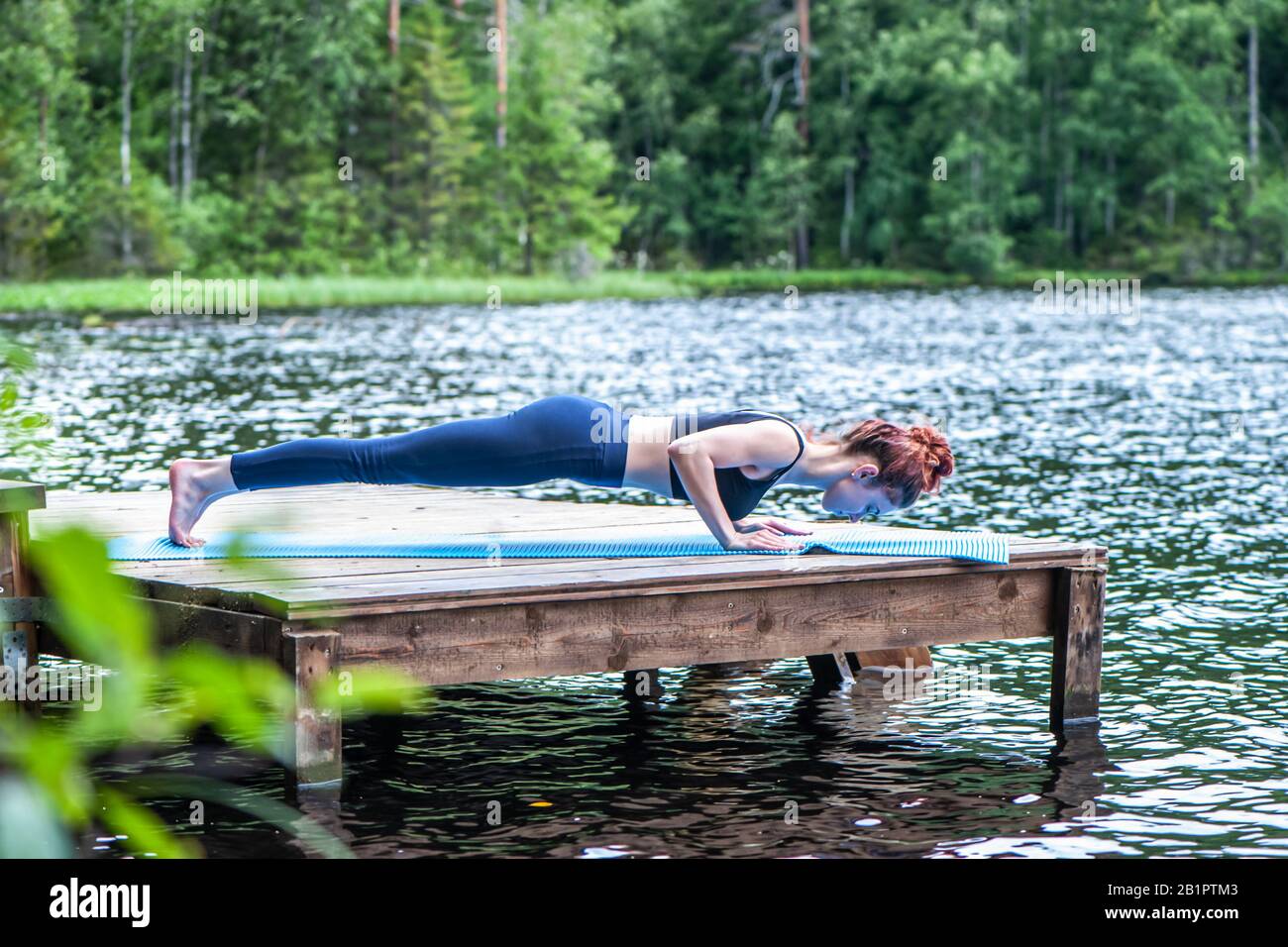 Young yogi girl practicing yoga, doing four limbed staff, chaturanga ...