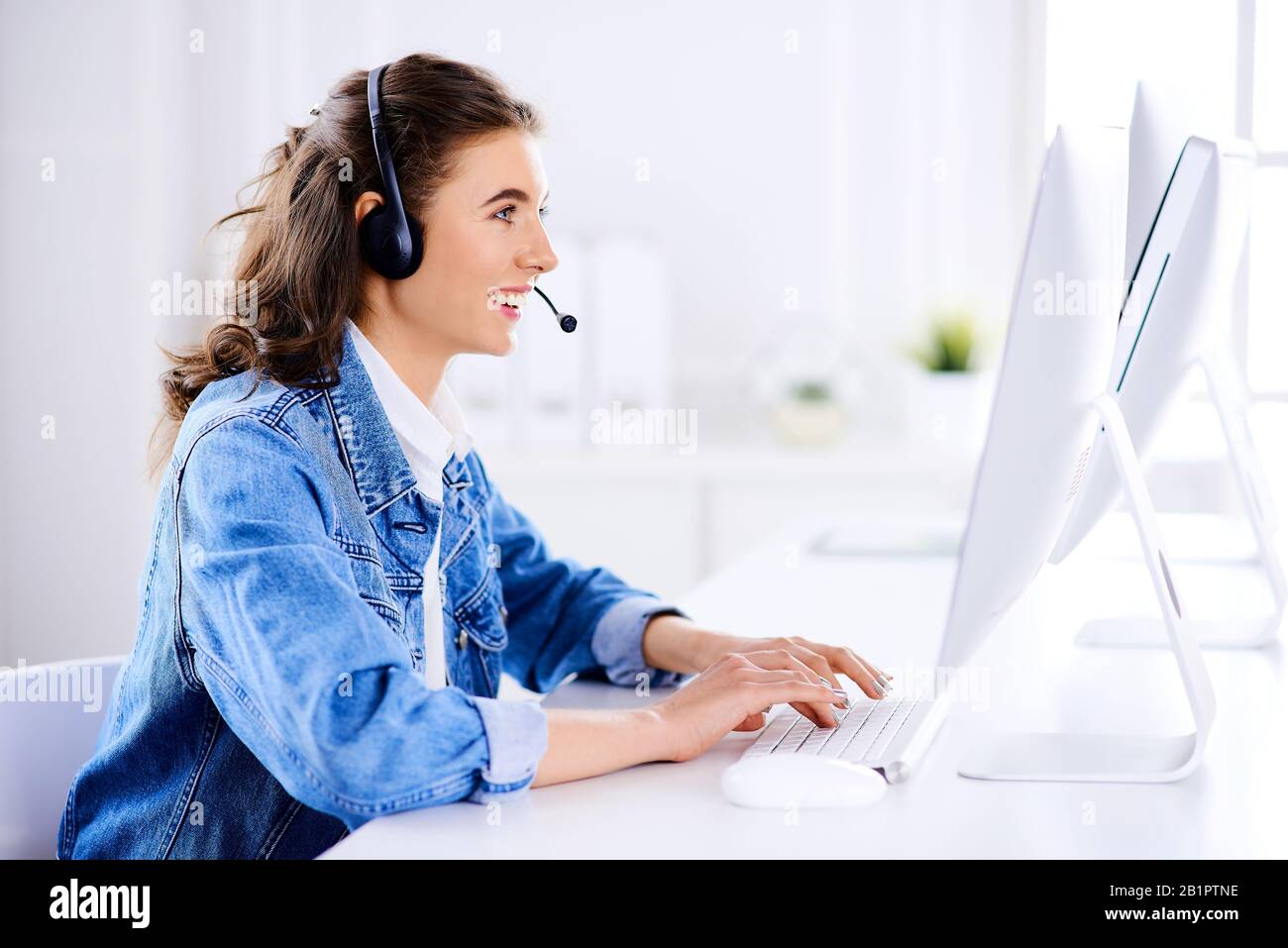 Female technical support agent in office working on computer Stock ...