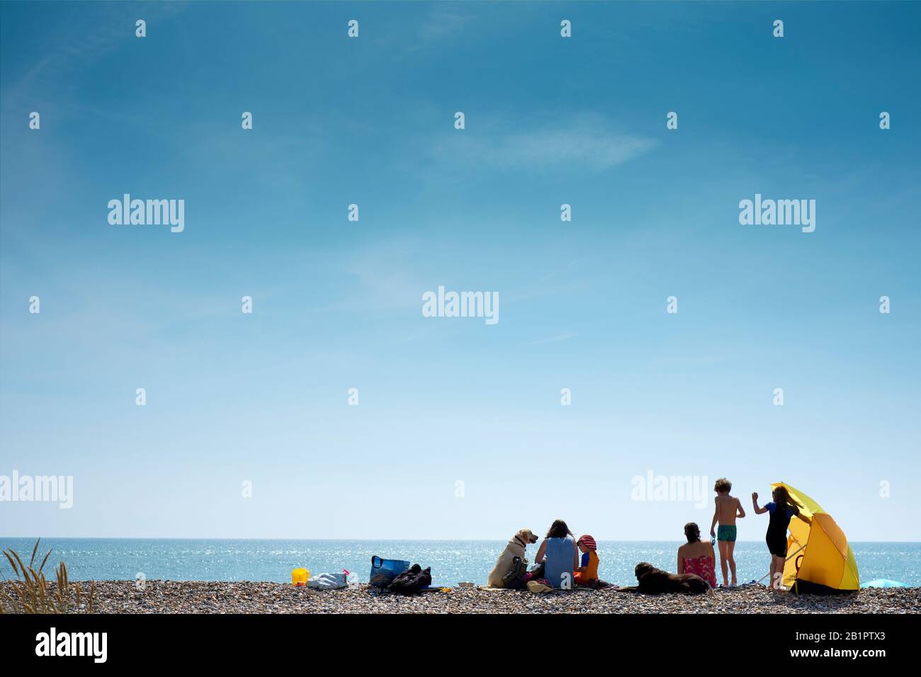 A family beach holiday on a summers day at the seaside, on the English ...