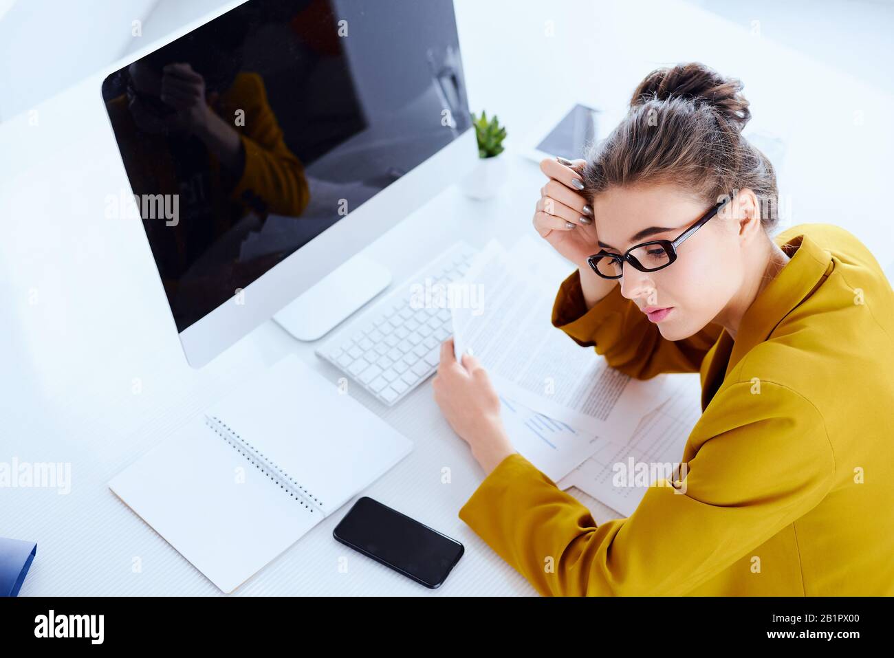 Top view of tired business woman with desktop and documents at her ...