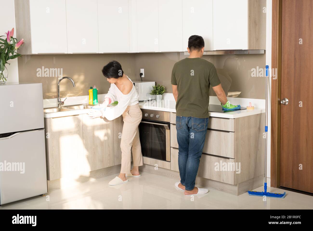 Young Asian Couple Cleaning Cleaning Modern Kitchen Stock Photo - Alamy