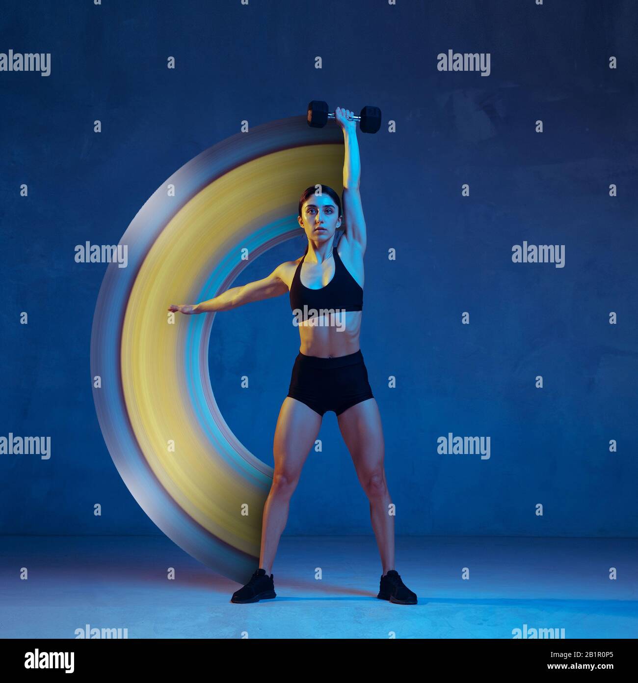 Concept of motion and action in sport. Young female athlete training ...