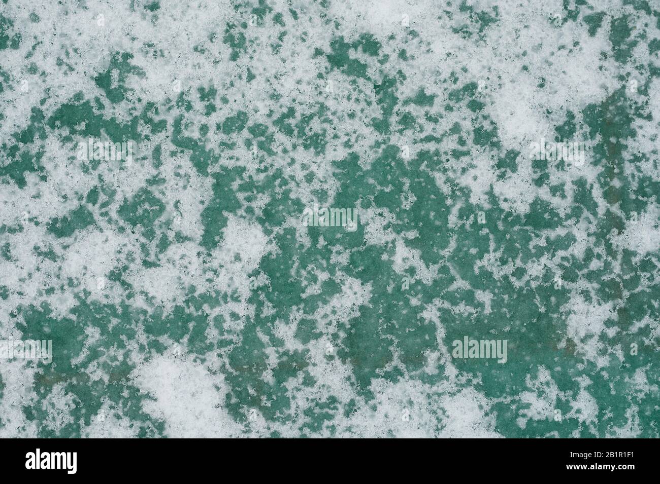 Melting snow background with green road backdrop Stock Photo - Alamy