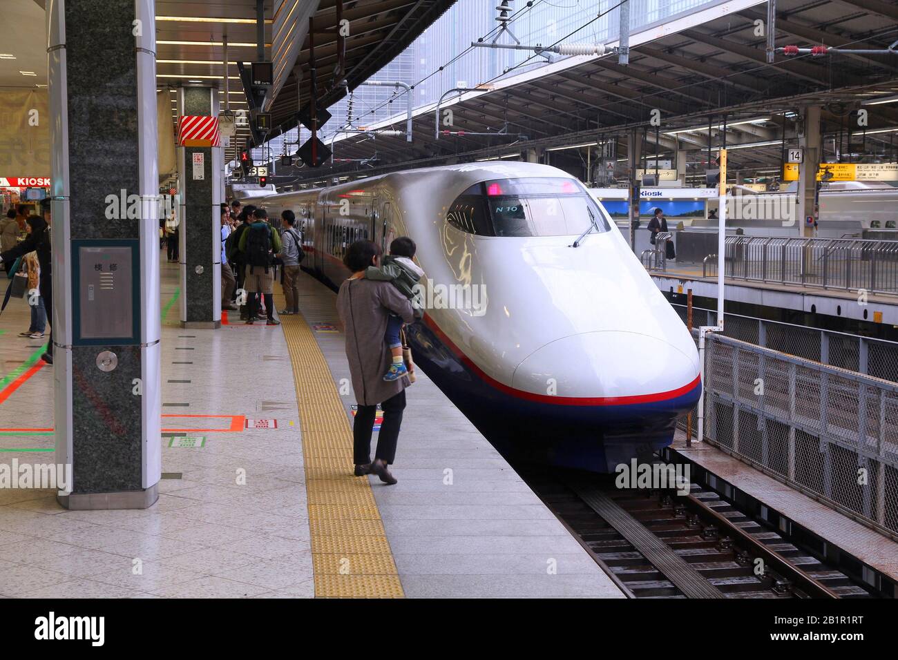 TOKYO, JAPAN - MAY 4, 2012: Travelers board Shinkansen Hayate train at ...