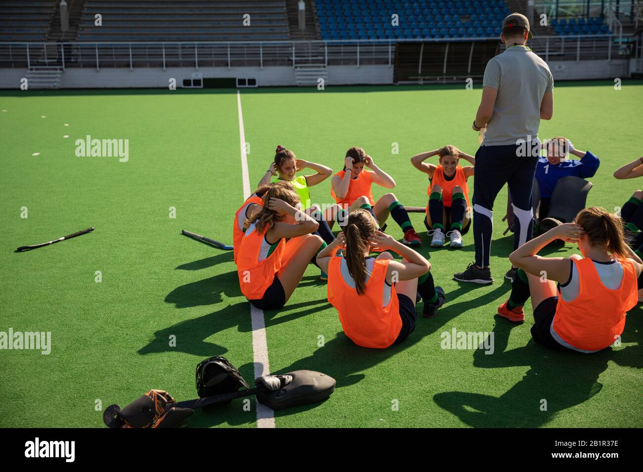 Female hockey players exercising on the field Stock Photo - Alamy