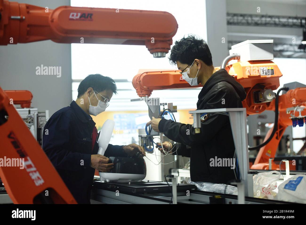 Chinese engineers test newly-manufactured robot arms at the plant of ...