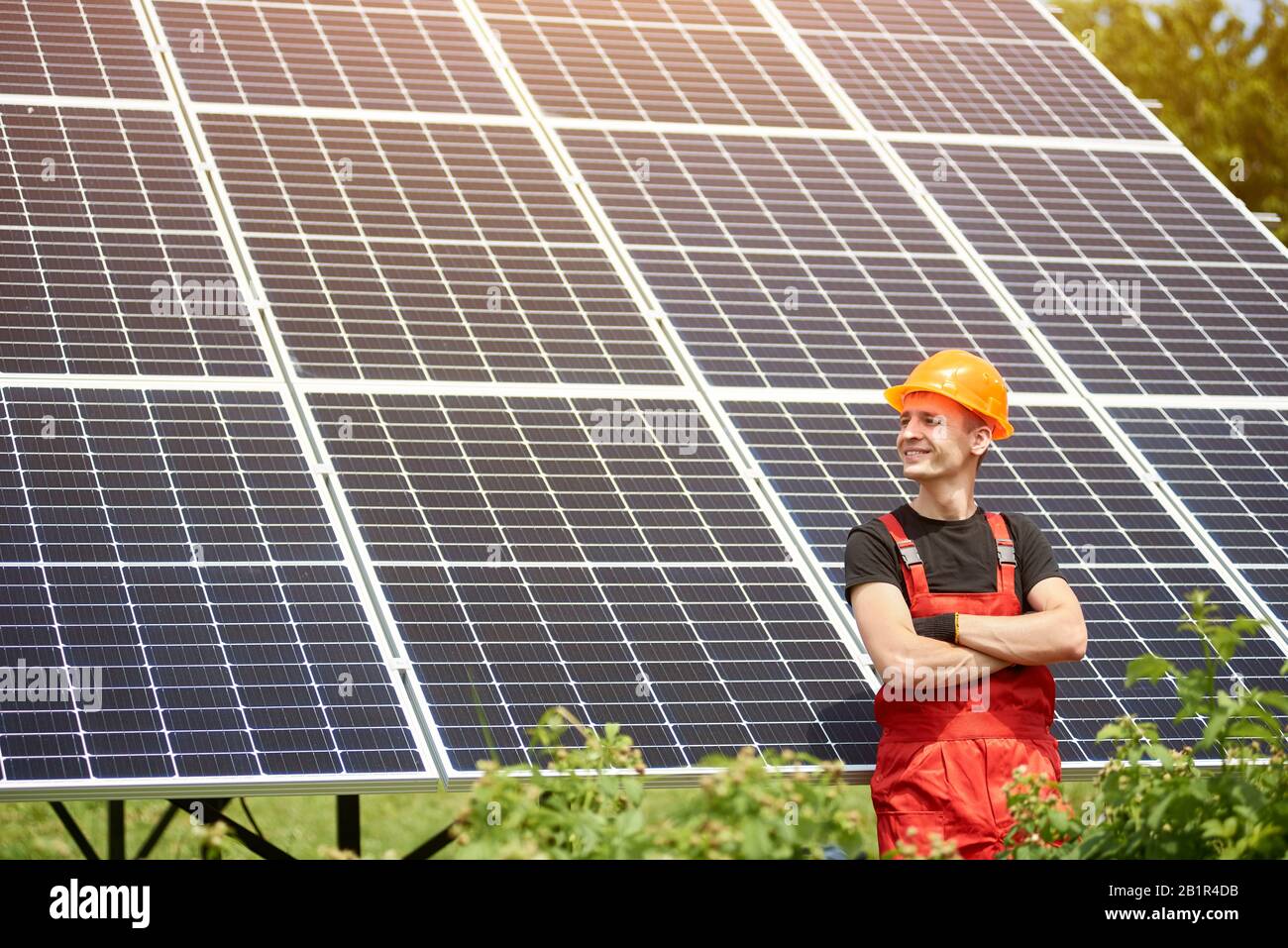 Proud young engineer smiling satisfied with his successful work with ...