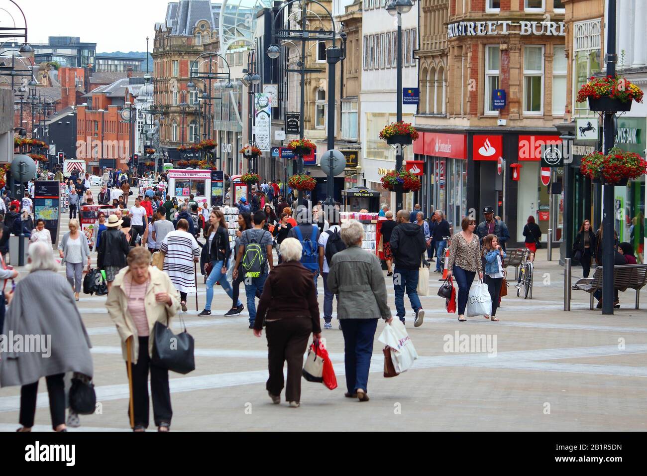 LEEDS, UK - JULY 12, 2016: People shop at Briggate street in downtown ...