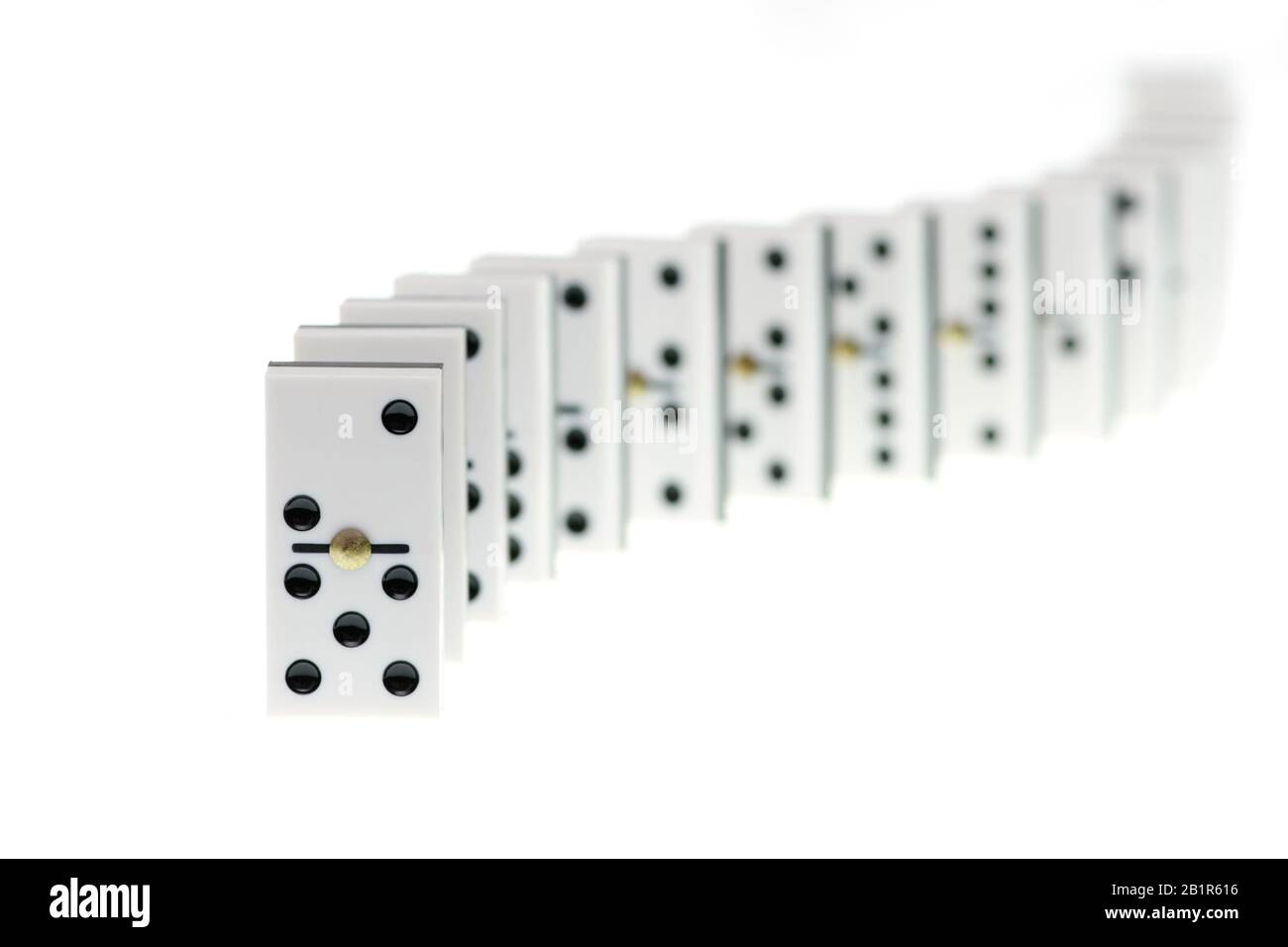 Chain of white domino stones on white background, focus on first Stock ...
