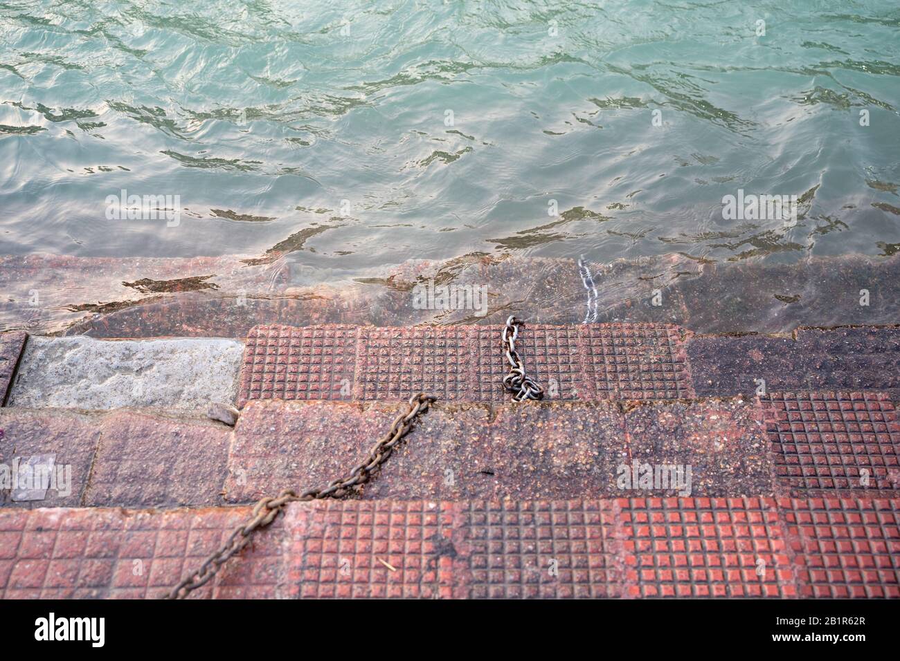 Chain along the ghats of the Ganges River lets bathers in the holy ...