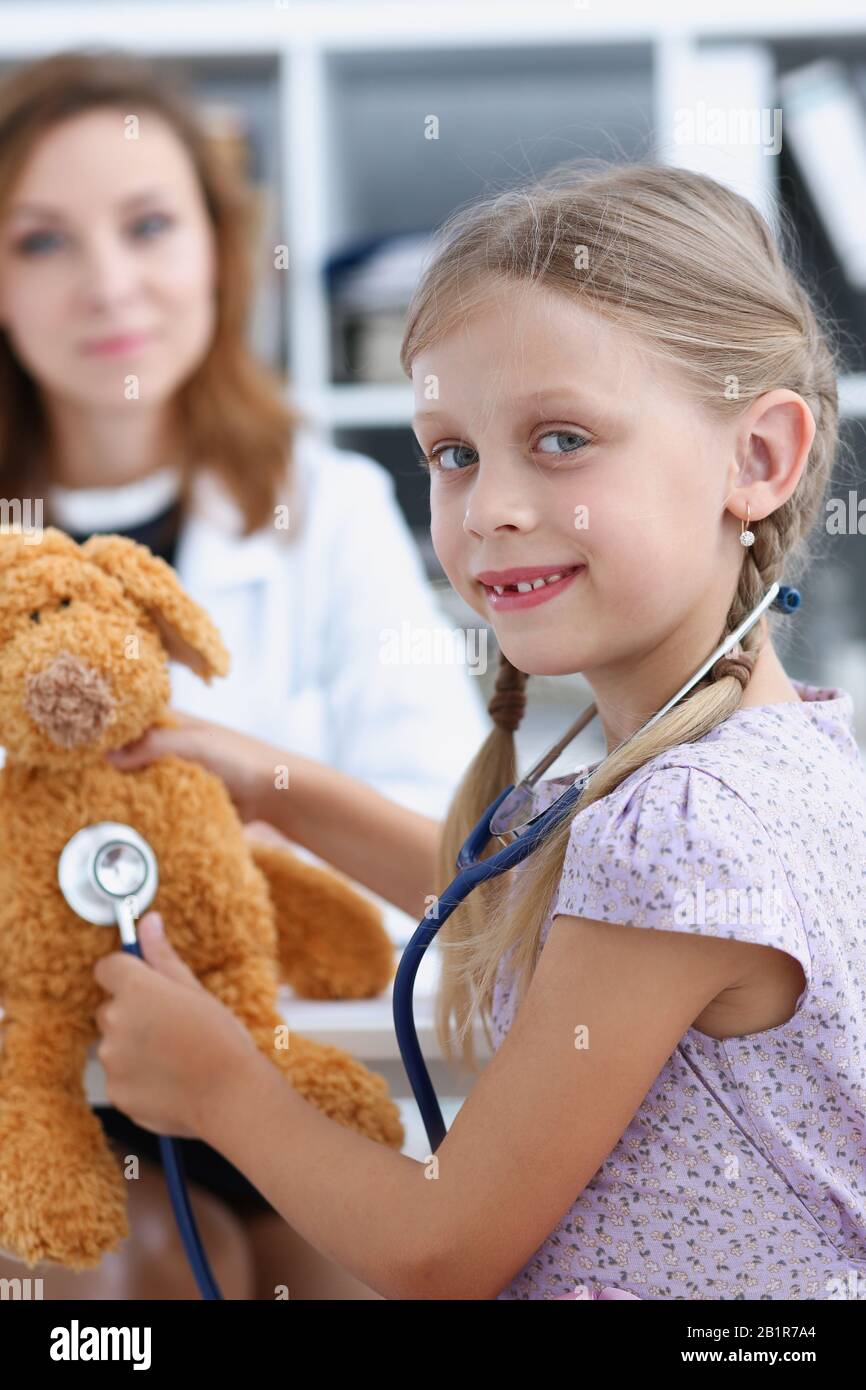 Little child with stethoscope at doctor reception Stock Photo - Alamy