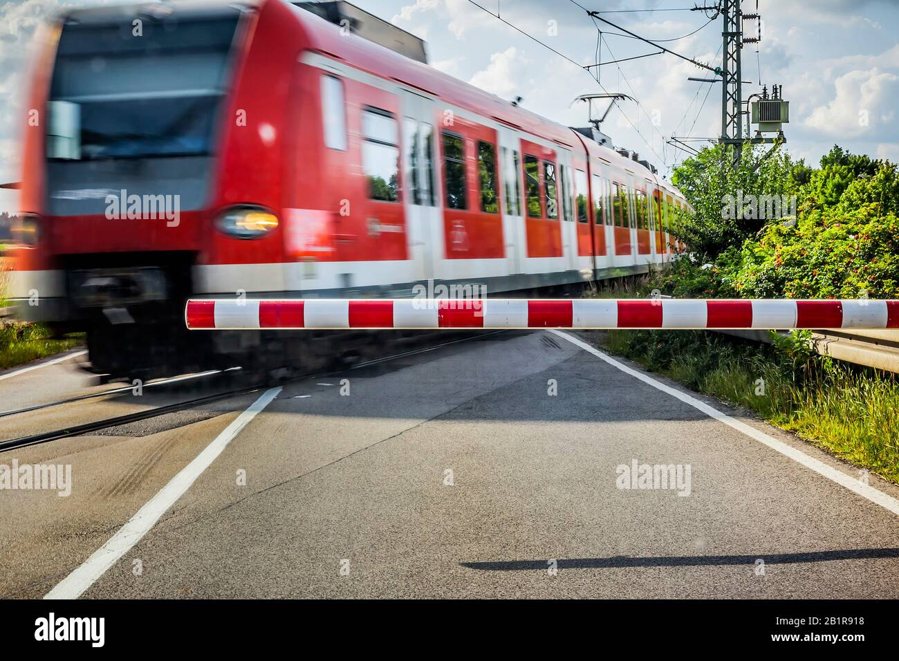 train at railroad crossing, Germany Stock Photo - Alamy
