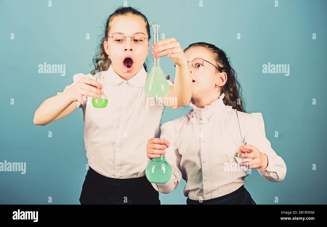 Improving modern medicine. little smart girls with testing flask. back ...