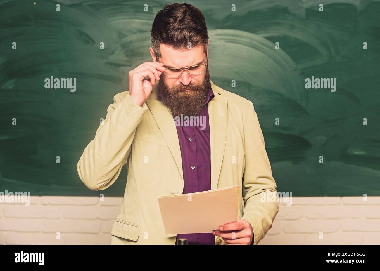 Prepare for test. Teacher bearded man hold documents chalkboard ...