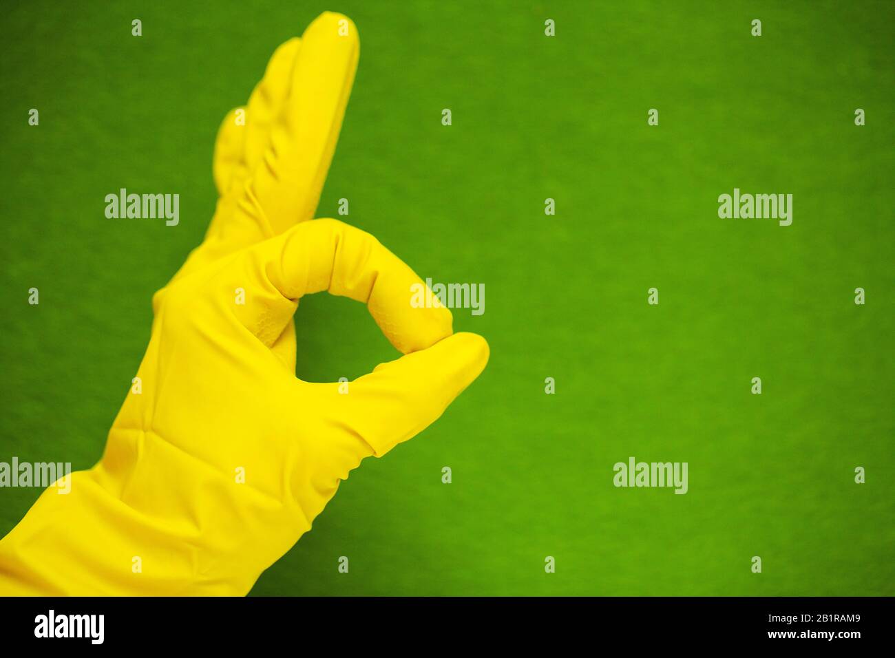 Product for professional cleaning on green background Stock Photo - Alamy