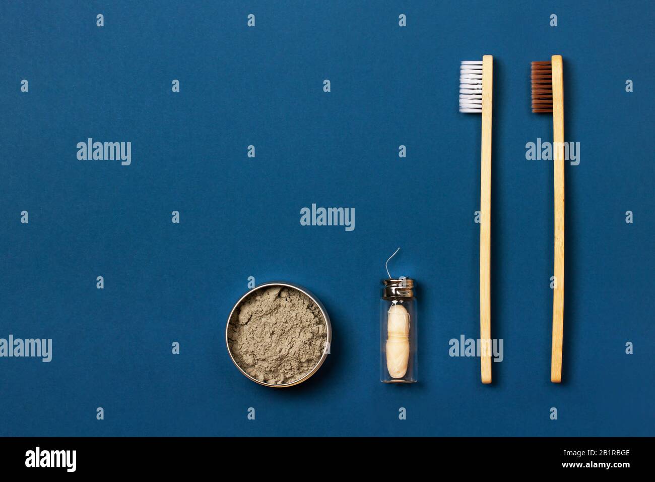 Set of eco-friendly tooth care items on the blue background. Bamboo ...