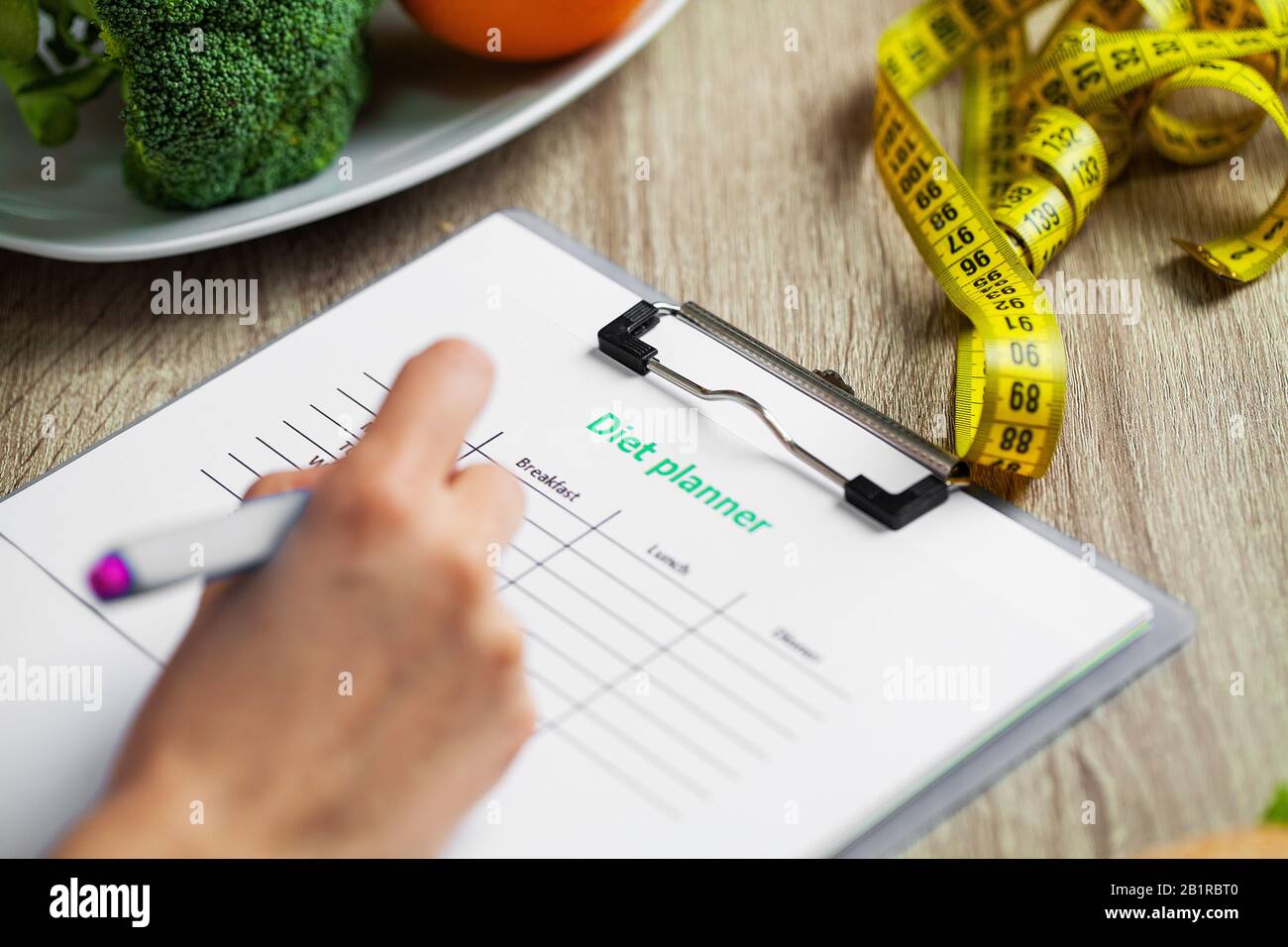 Nutritionist prepares a diet plan for an overweight woman Stock Photo ...