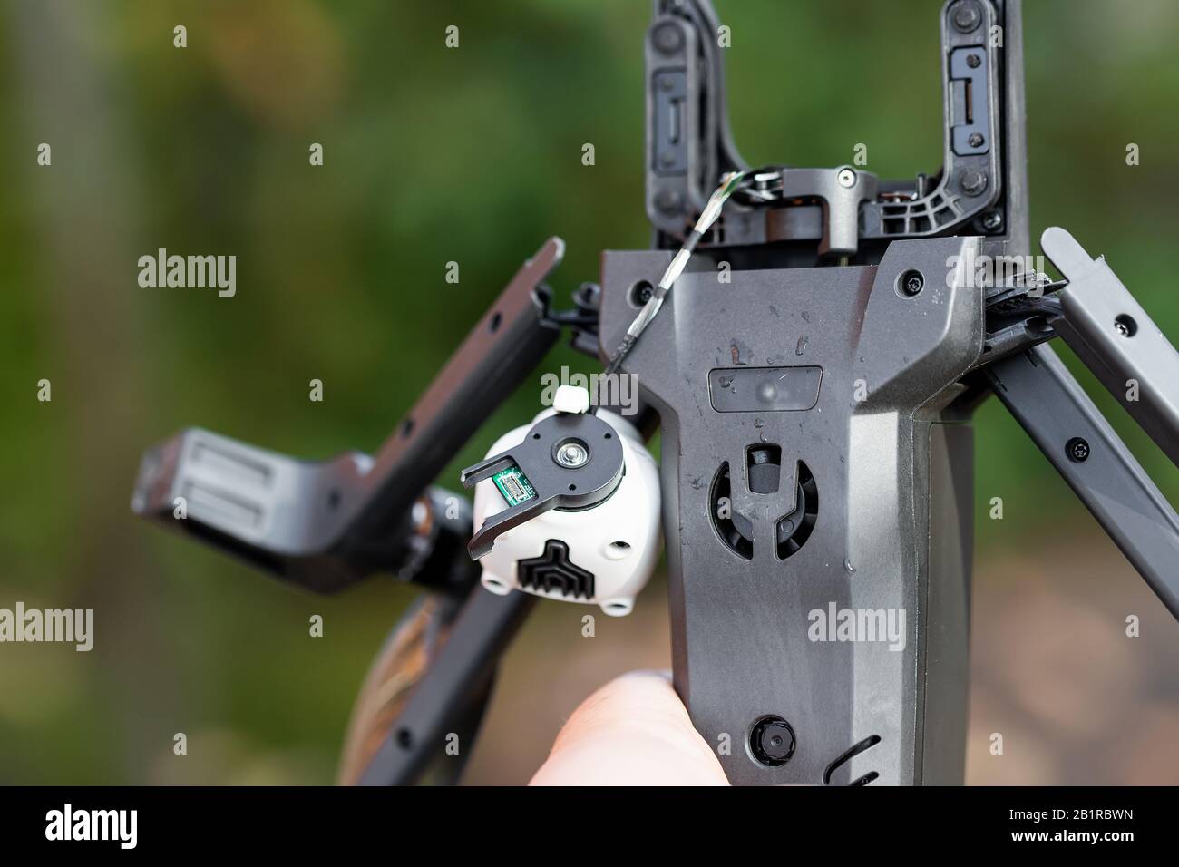 Pilot holding in hand broken black quadcopter drone uav after crash ...