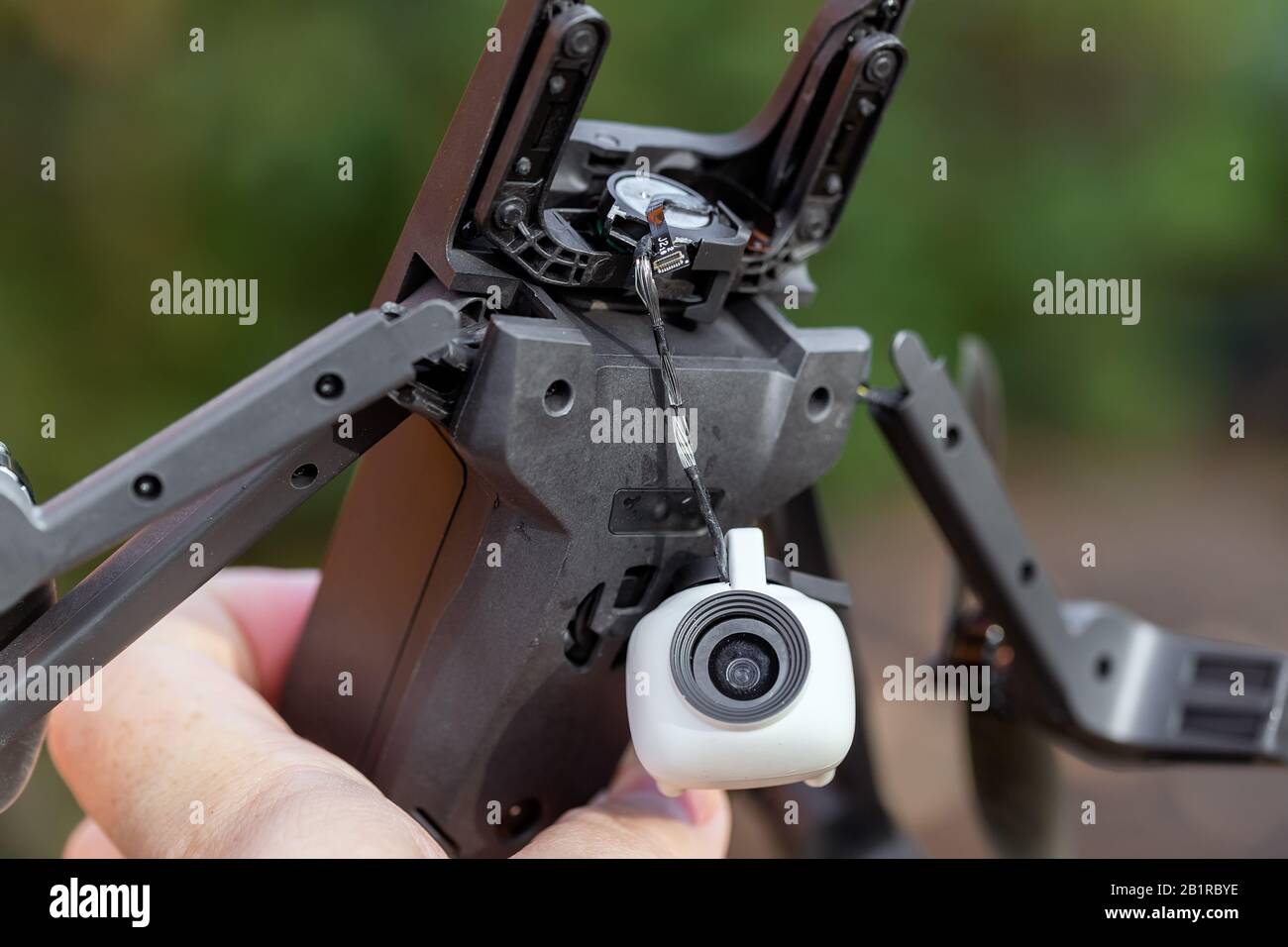 Pilot holding in hand broken black quadcopter drone uav after crash ...