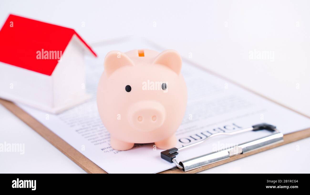 Piggy bank, beautiful wooden house model over a signed contract on ...