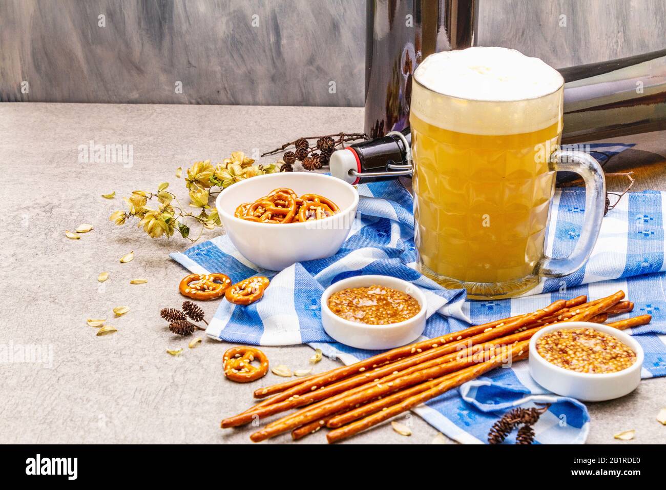 Oktoberfest set. Light beer, pretzels, mustard, sesame straw, hop ...