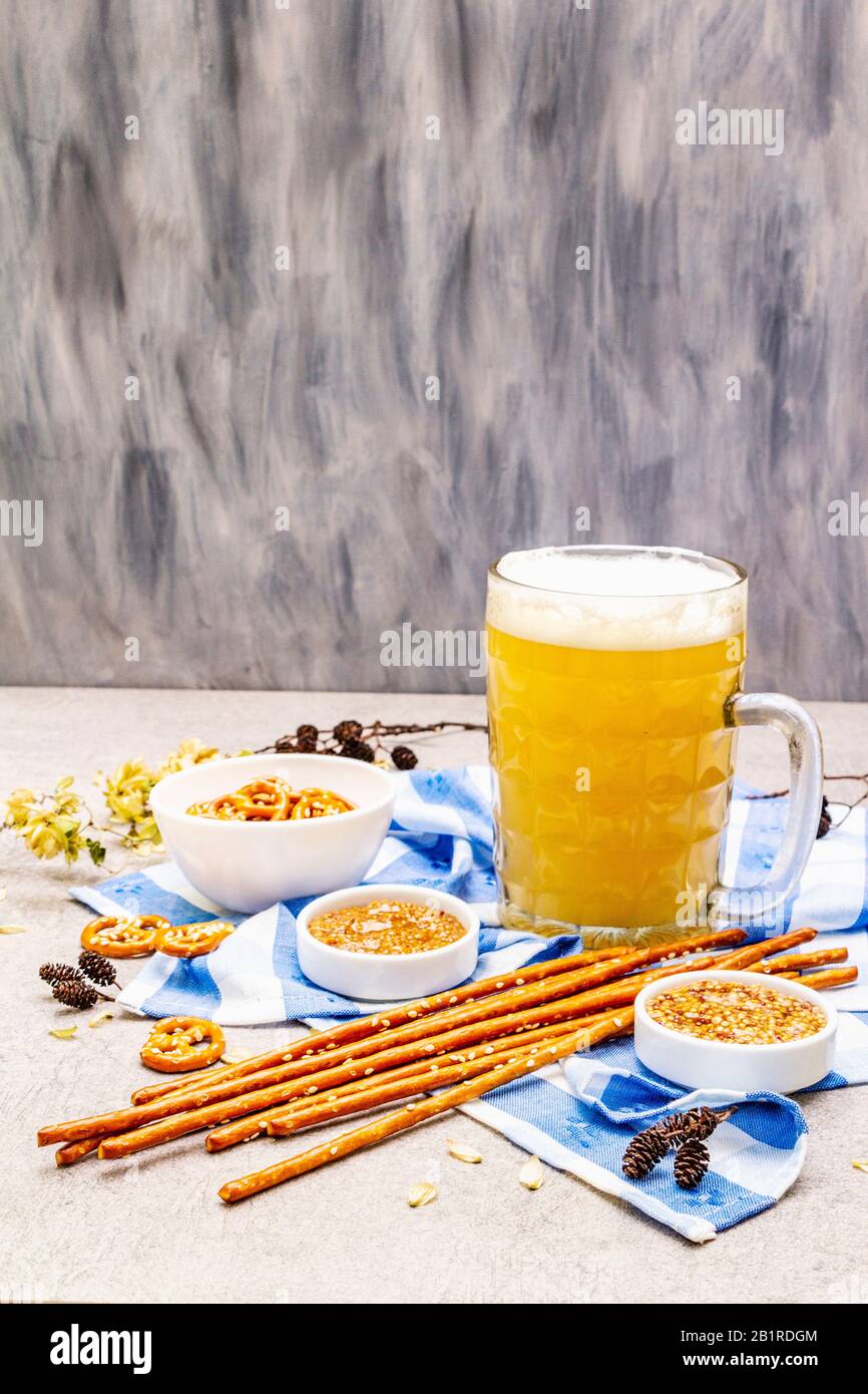 Oktoberfest set. Light beer, pretzels, mustard, sesame straw, hop ...