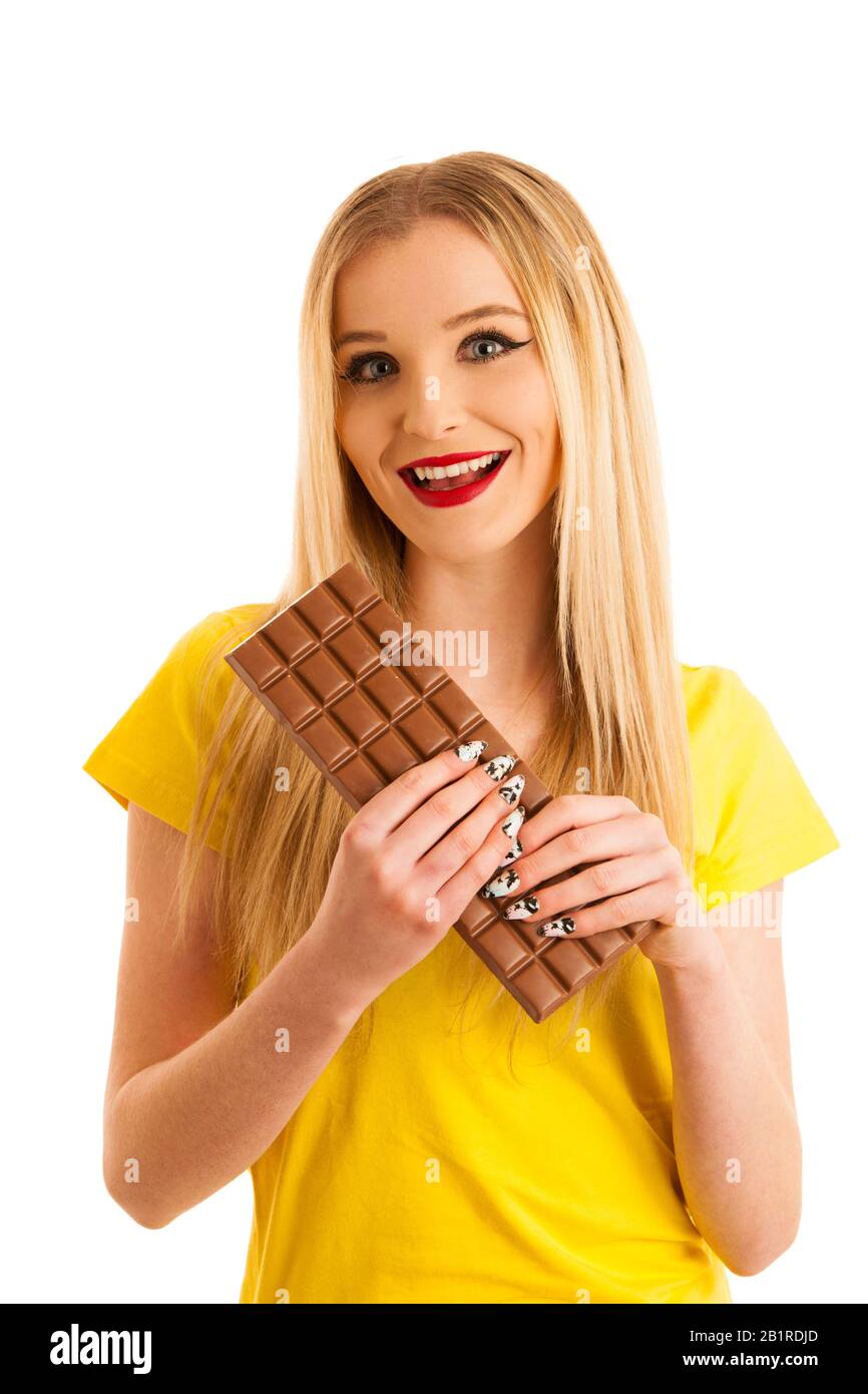 Cute young woman eating chocolate isolated over white background Stock ...