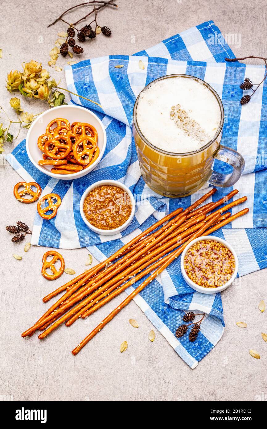 Oktoberfest set. Light beer, pretzels, mustard, sesame straw, hop ...