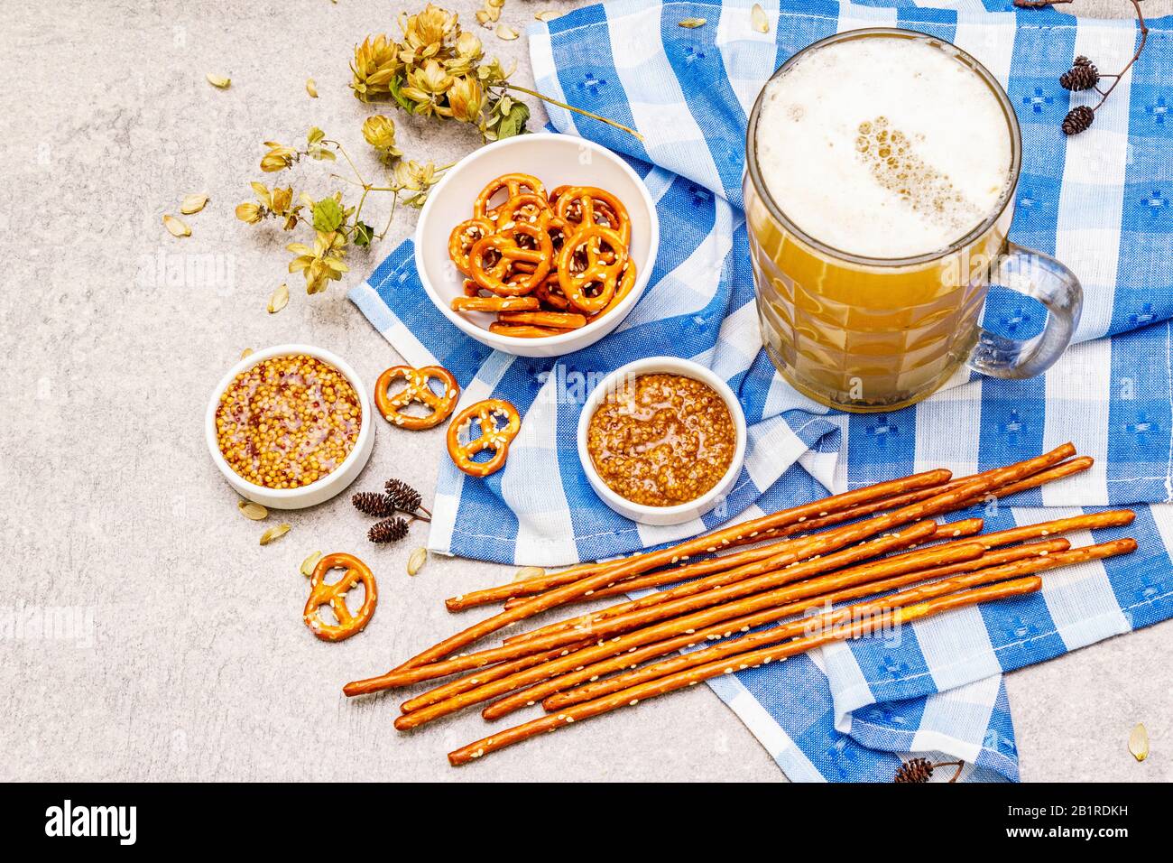 Oktoberfest set. Light beer, pretzels, mustard, sesame straw, hop ...