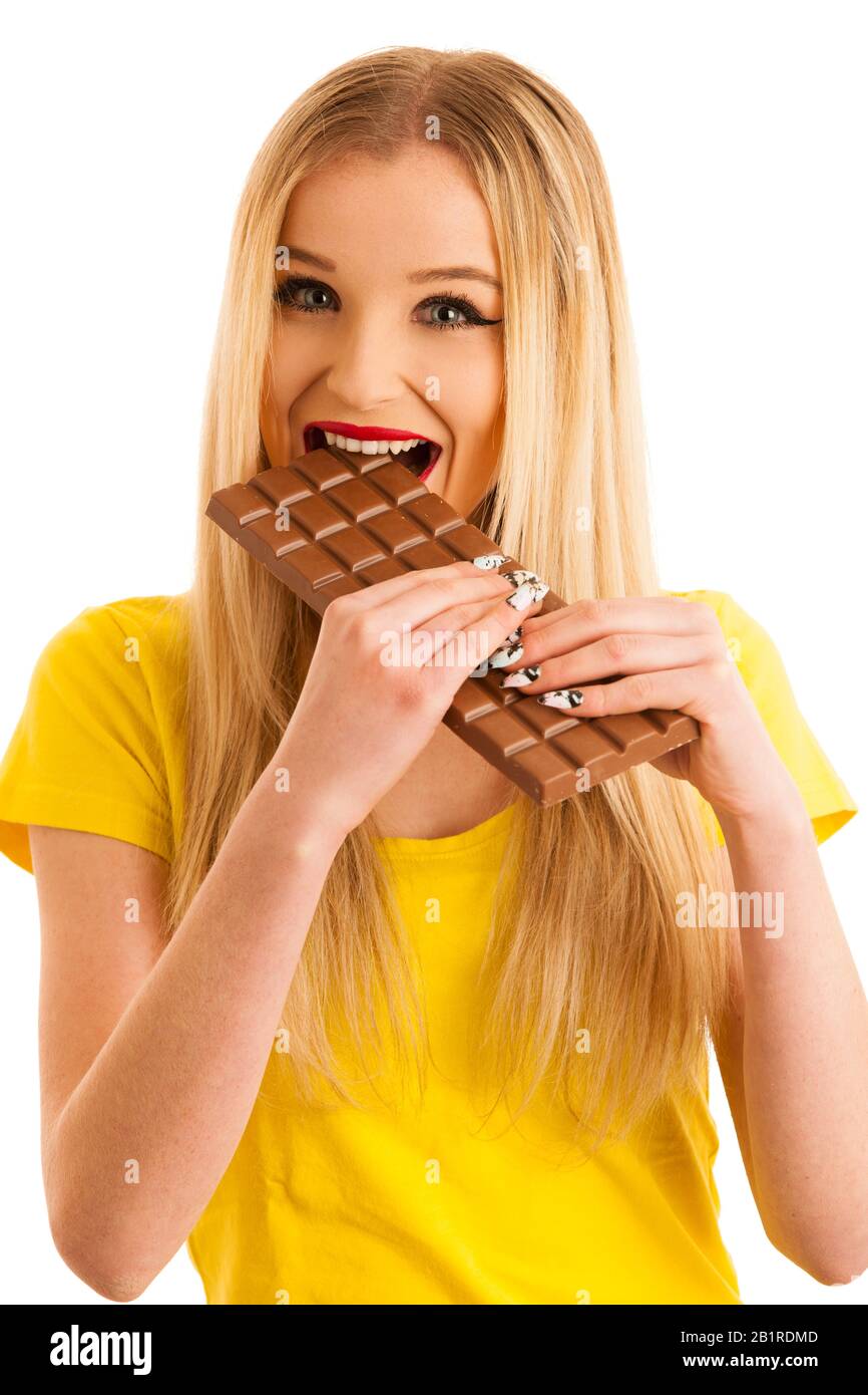 Cute young woman eating chocolate isolated over white background Stock ...
