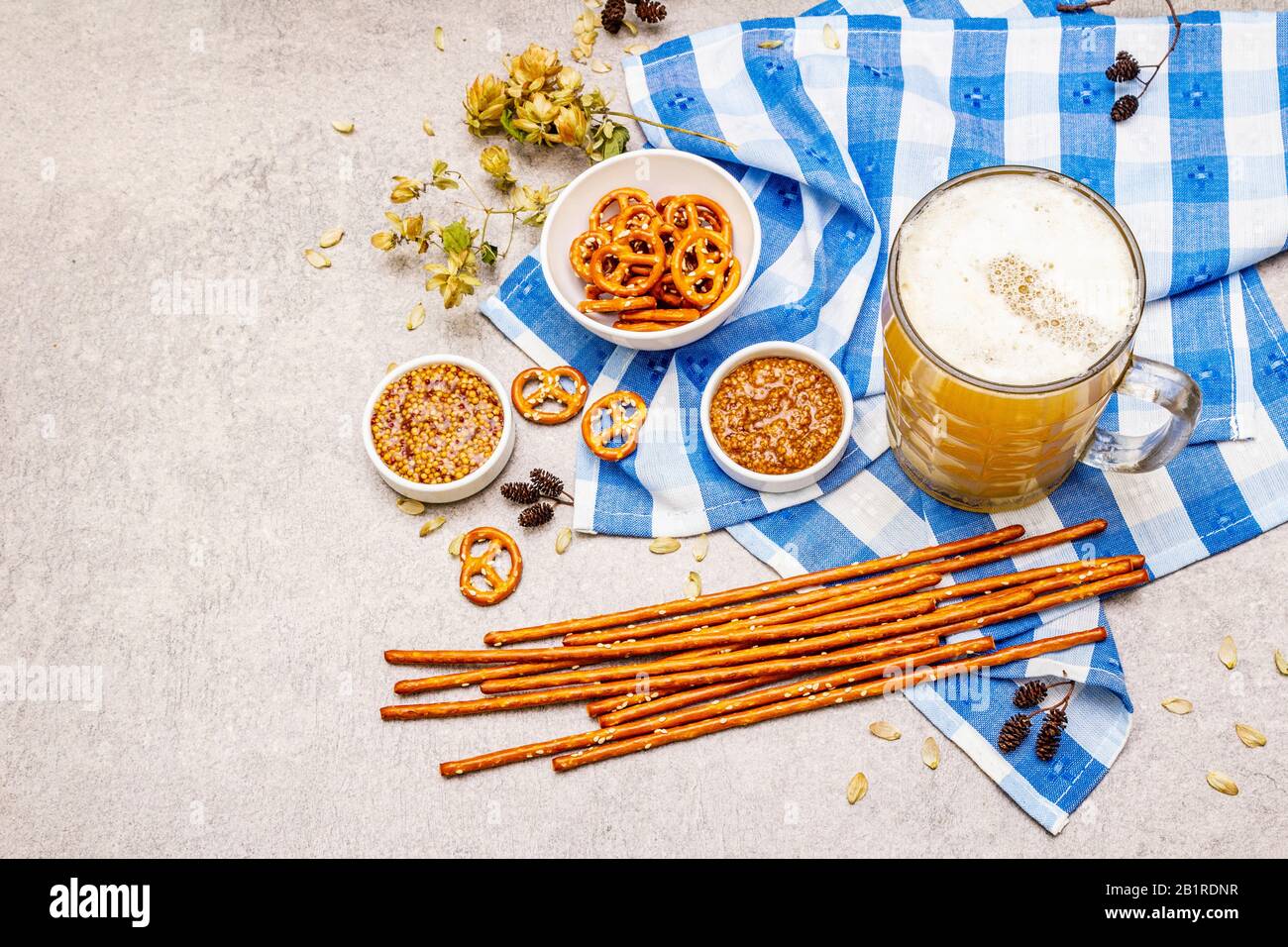 Oktoberfest set. Light beer, pretzels, mustard, sesame straw, hop ...