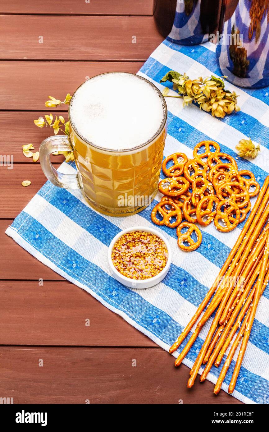 Oktoberfest set. Light beer, pretzels, mustard, sesame straw, hop ...