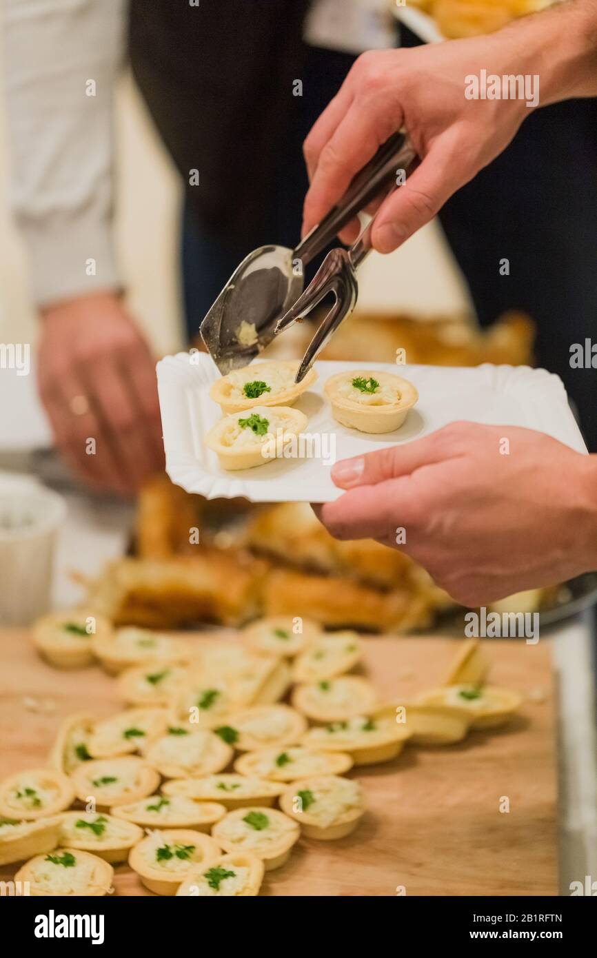 Man serving himself with vegetarian canapes at celebration event Stock ...