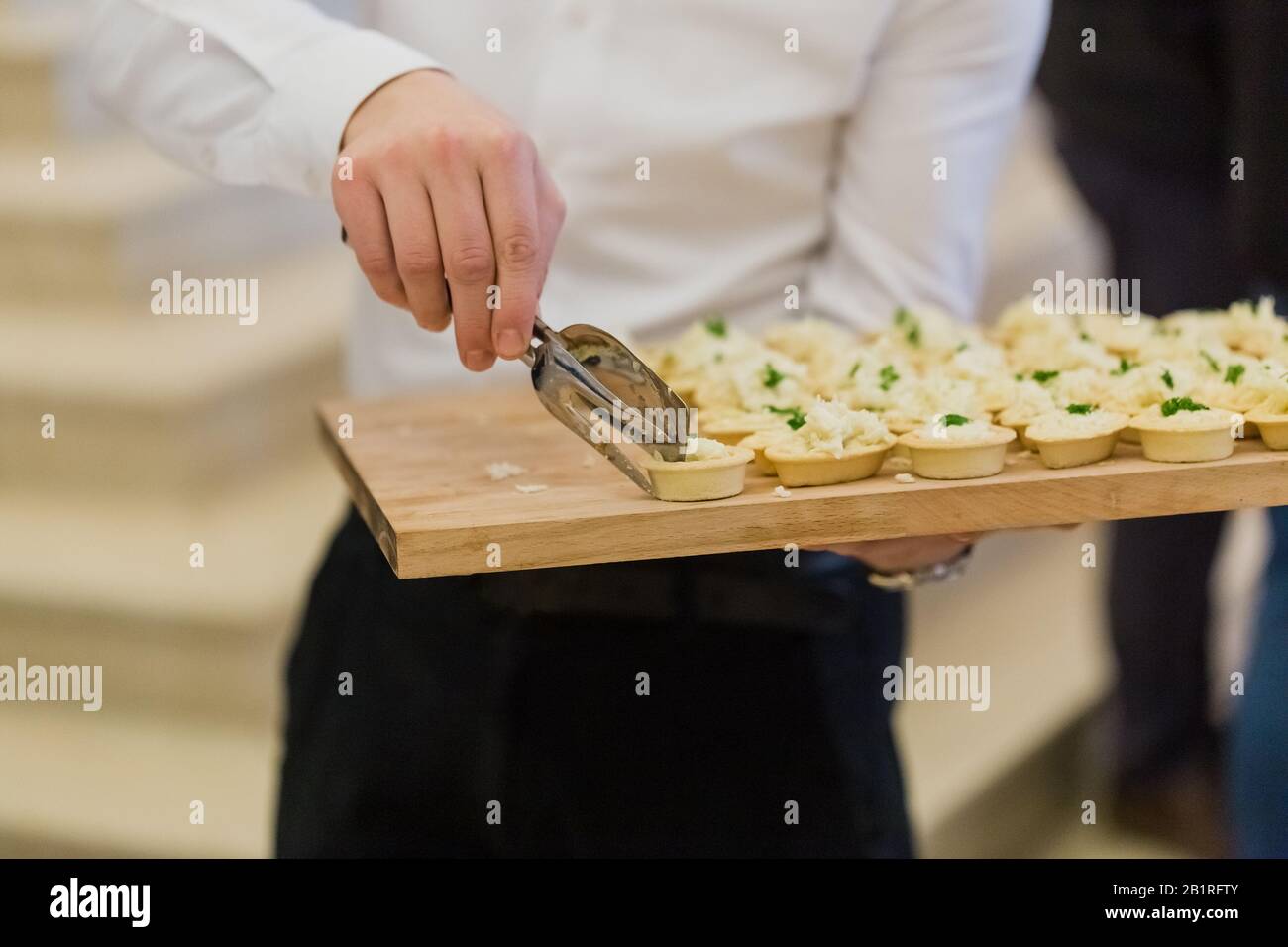 Waiter serving vegetarian canapes at celebration event Stock Photo - Alamy