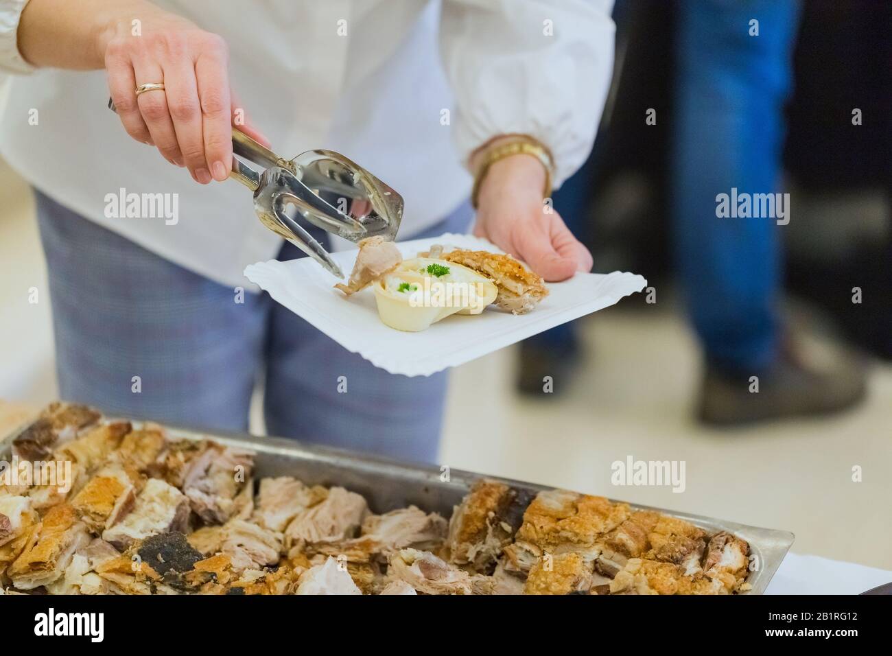 Fashionable woman serving herself with food on banquet or celebration ...