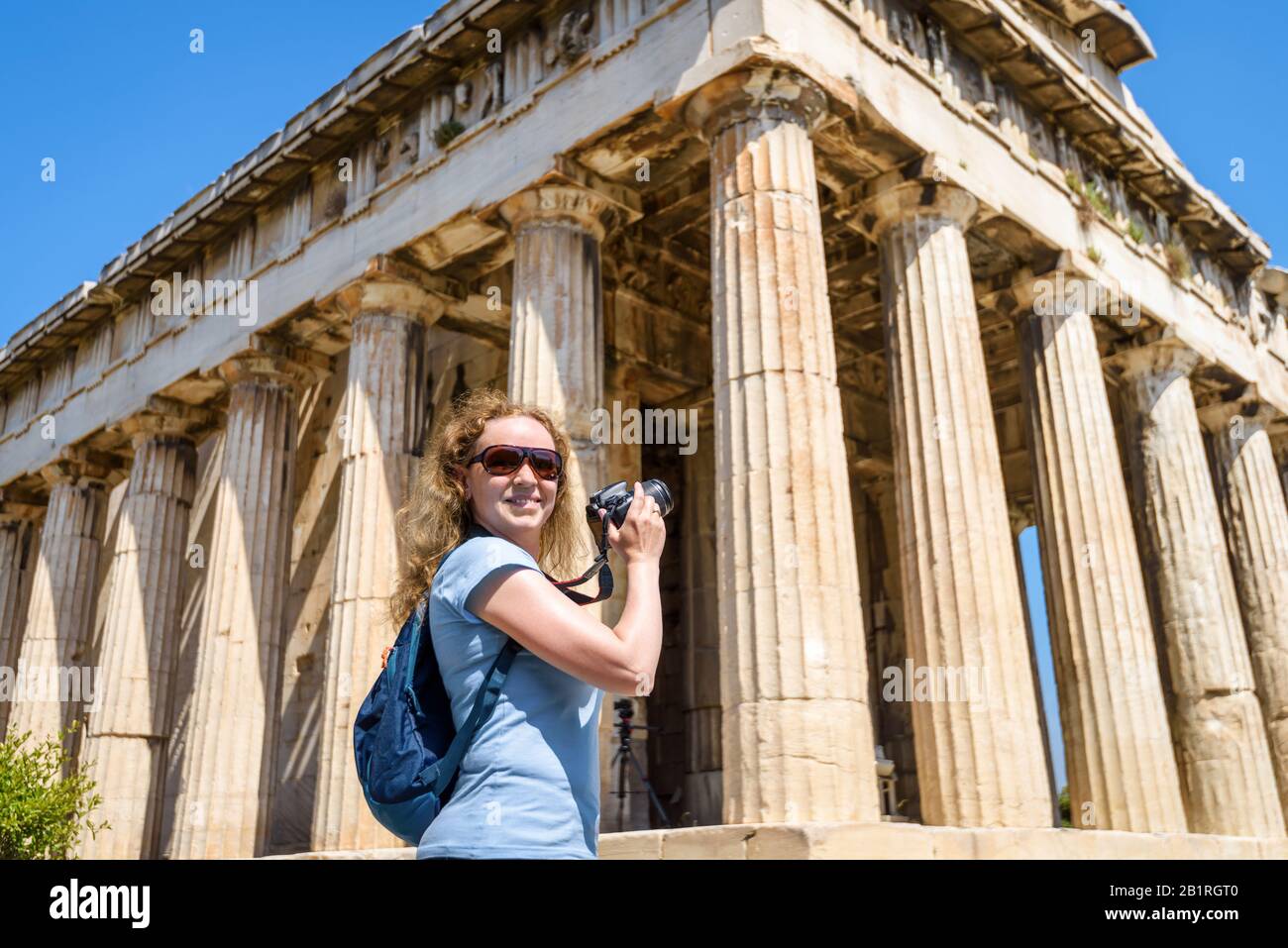 Young woman takes a picture of Temple of Hephaestus in Agora, Athens ...