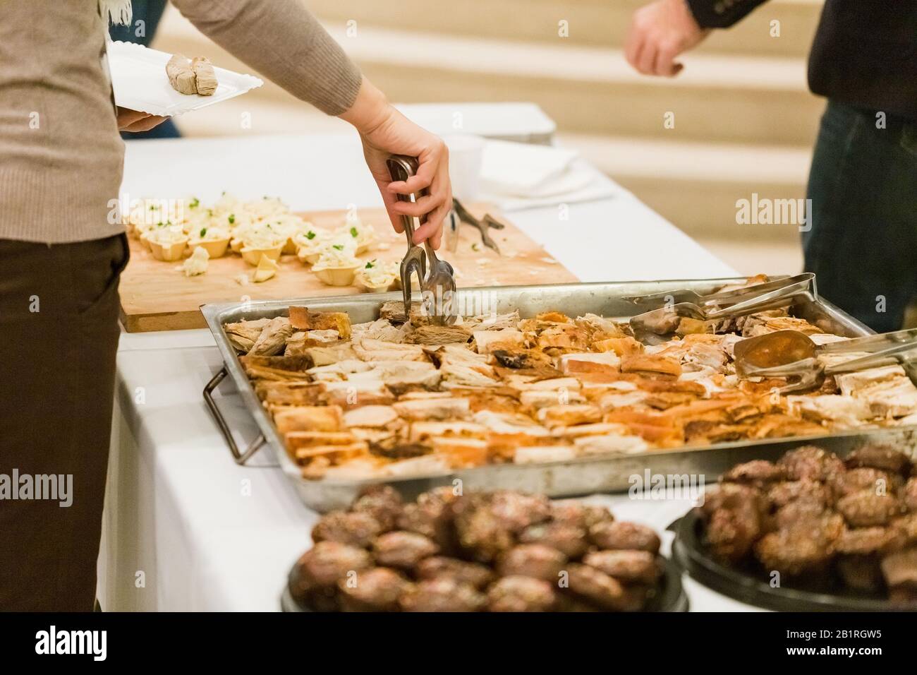 Woman serving herself with food at restaurant event or conference Stock ...