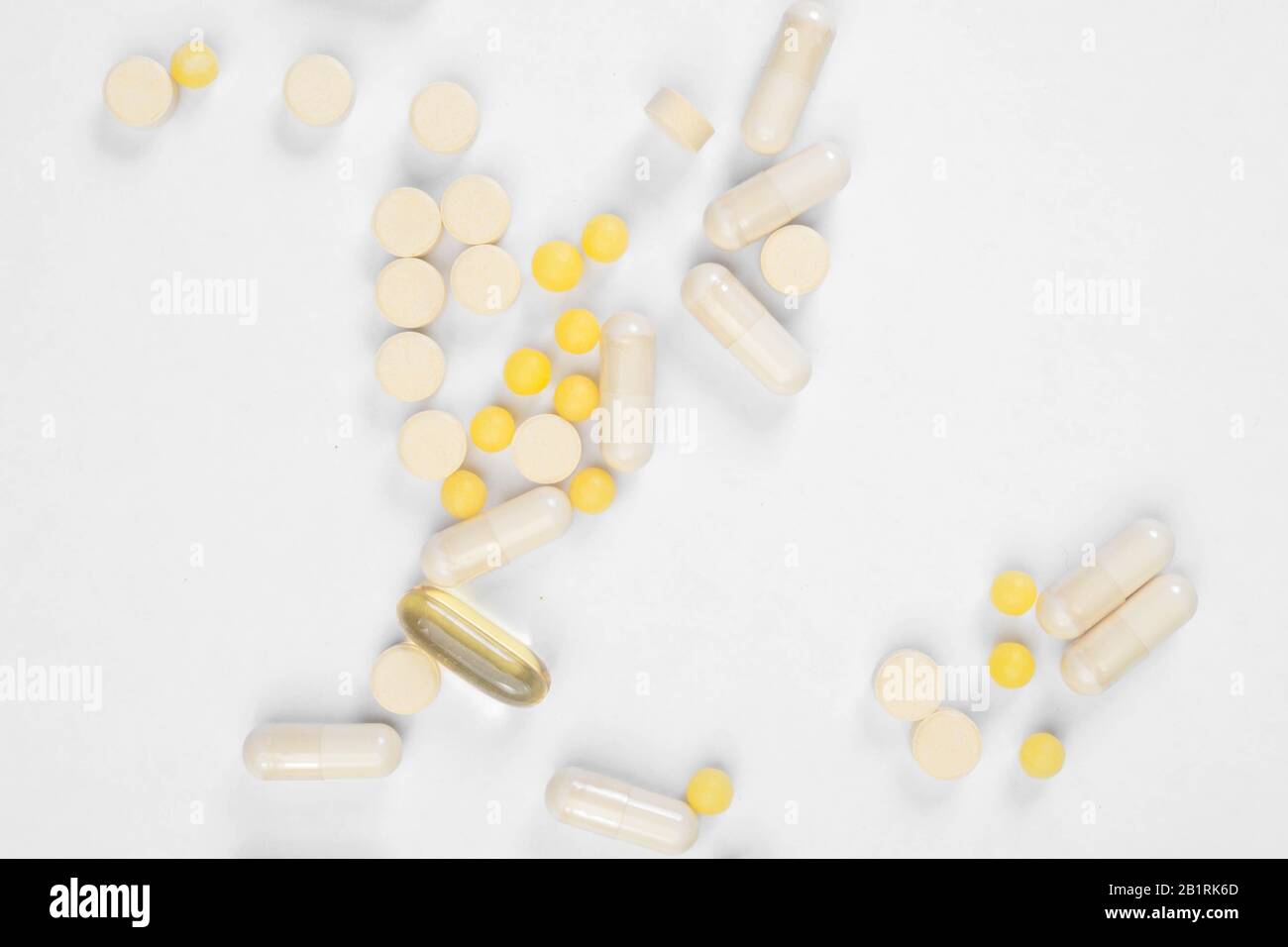 mixed pills capsules tablets on white background, close up. Medicine ...